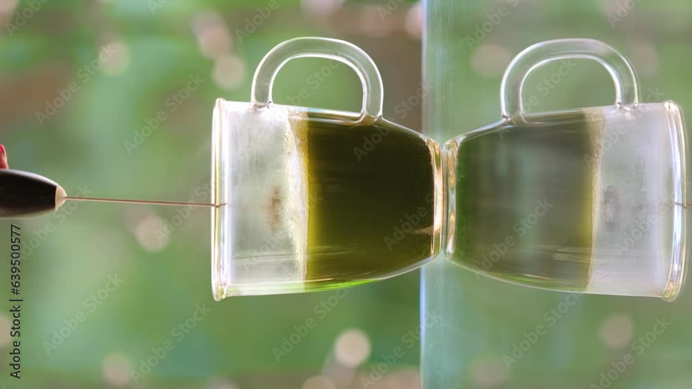 Process making matcha green tea. Green matcha tea powder falls into a ...