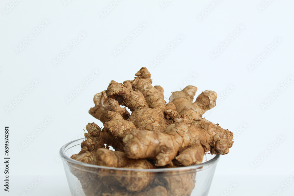 Zingiber officinale rhizome or ground ginger root, inside a transparent ...