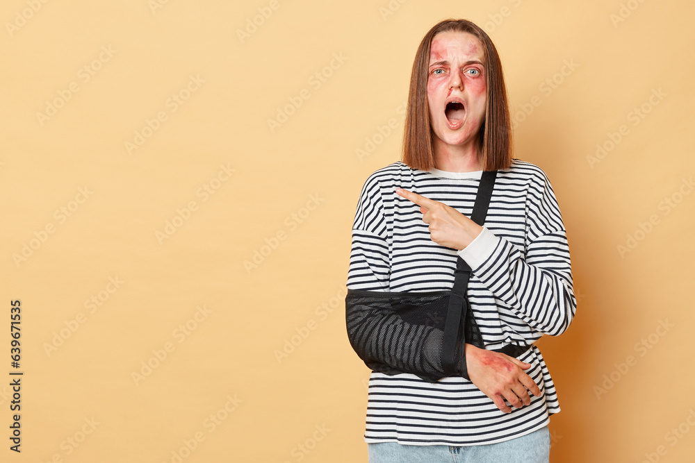 Shocked scared woman with scratches and bruises on face with bandage ...