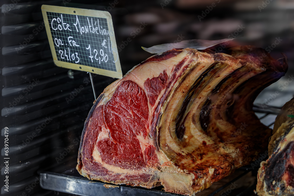 Aged beef prime rib at a French butcher shop counter, a local farmers ...