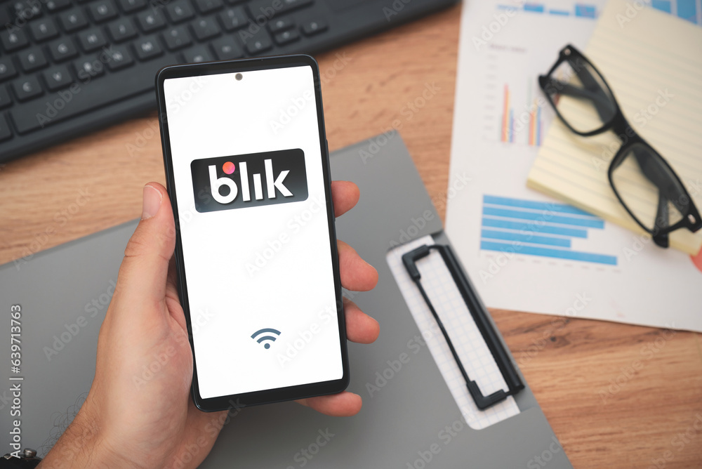 Man holding smartphone with Blik payment service Stock Photo | Adobe Stock