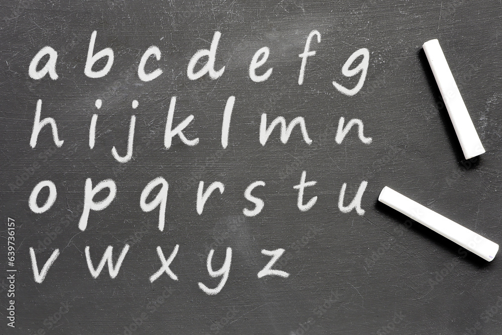 Set of English alphabet handwritten in white chalk on blackboard ...