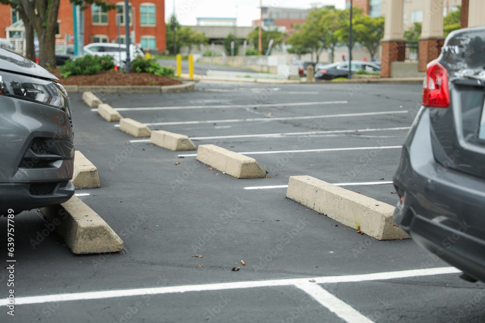 parking lot asphalt expanse, a modern desert of halted motion; a symbol ...