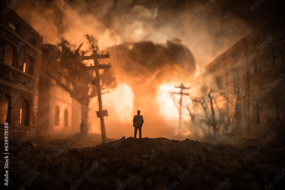 Foto de Artwork decoration. A man standing on a road of burnt up city ...