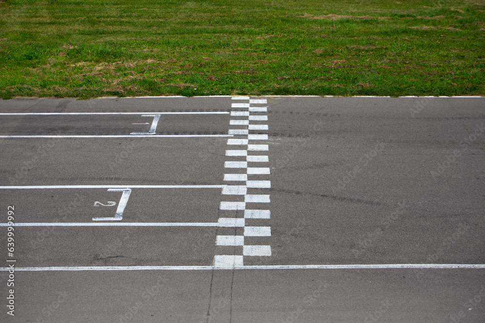 Finish line at the go-kart race track, side view. Asphalt track with ...