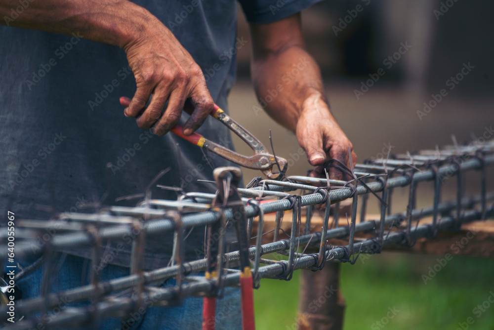 Construction Men hands bending cutting steel wire fences bar ...