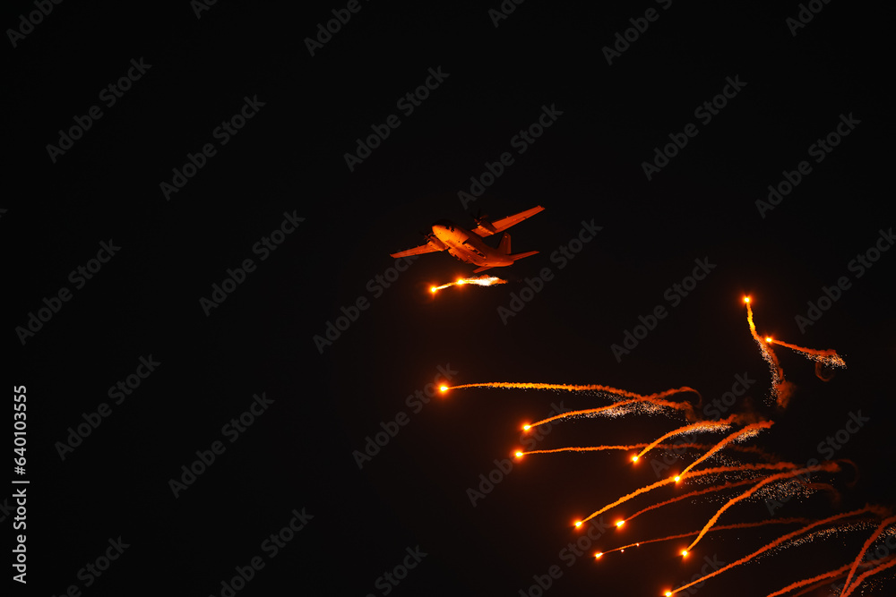 C27J Spartan military aircraft throwing rockets missiles during a night ...