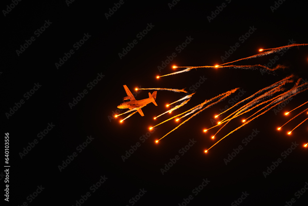 C27J Spartan military aircraft throwing rockets missiles during a night ...