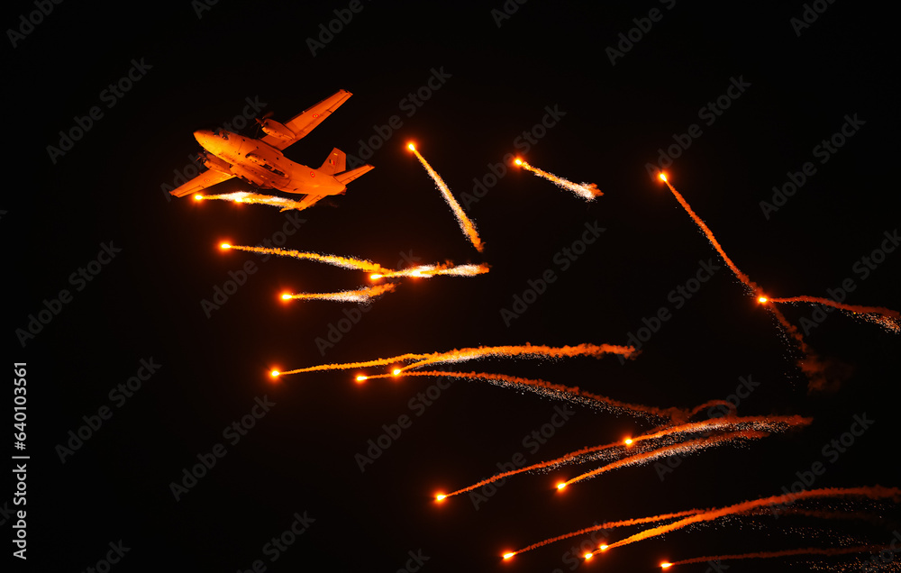 C27J Spartan military aircraft throwing rockets missiles during a night ...