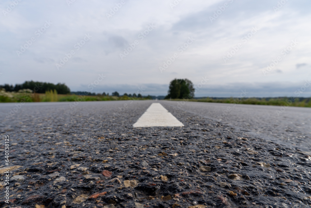 Asphalted road with white interrupted dividing line. Perspective of the ...