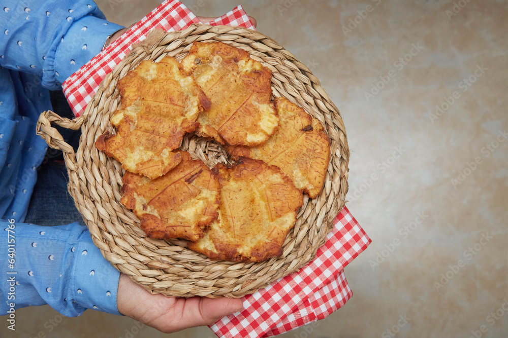 Patacones, also known as tostones, are thick pieces of fried green ...