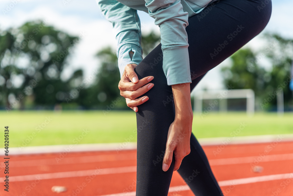 Close up female runner athlete with muscle pain. Woman massaging ...