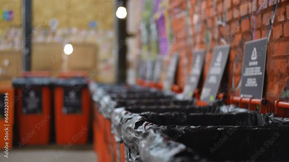 Rows of garbage bins for different types of trash at recycle station ...