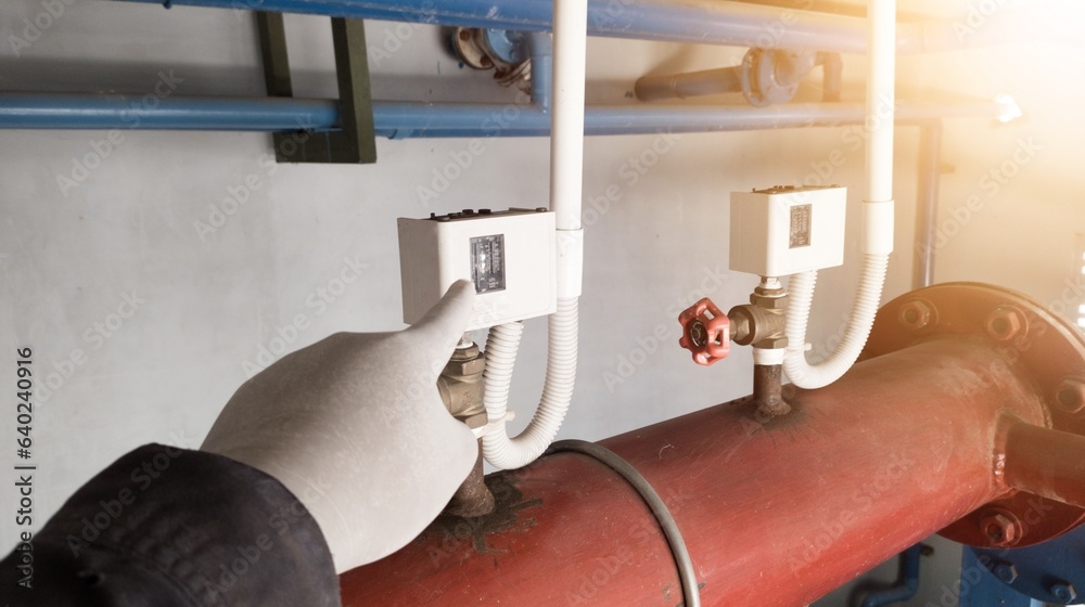 Hand pointed the Pressure control switch installed on the pipe water ...