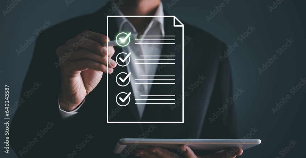 Business performance checklist, businessman using laptop doing online ...