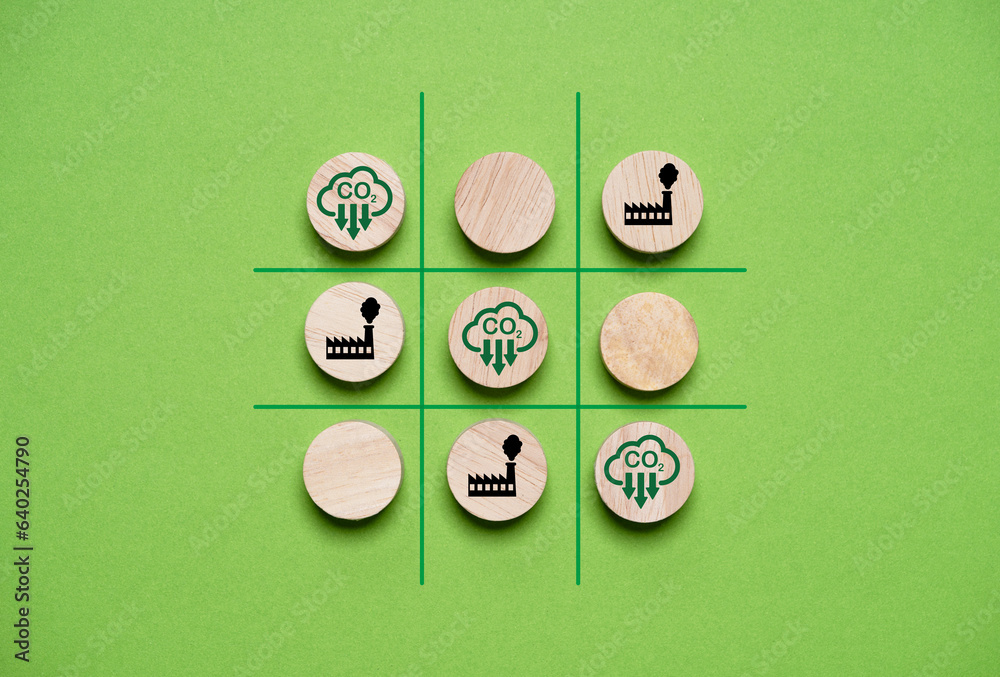 CO2 reducing icon and pollution factory on tic tac toe table for decrease CO2 emission, carbon ...