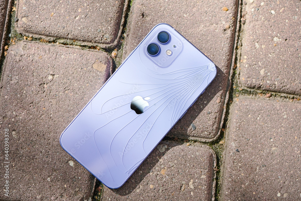 Apple Iphone 12 with broken glass case on concrete sidewalk. Damaged ...