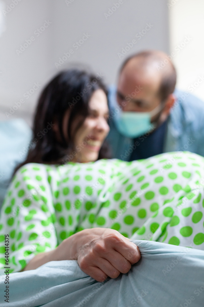 Pregnant woman trying to delivery baby in hospital ward, having husband ...