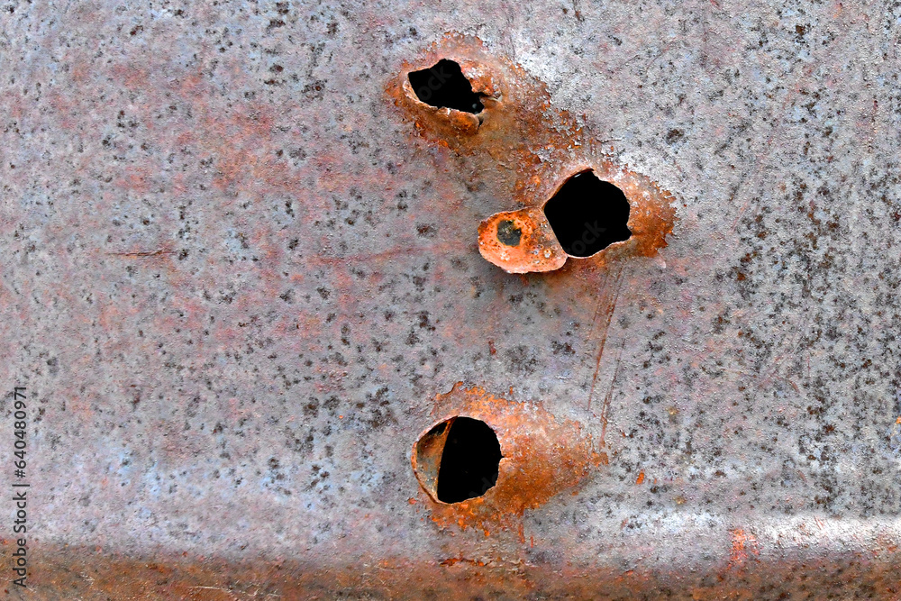 Exit Bullet holes in old corroded metal barrel Stock Photo | Adobe Stock