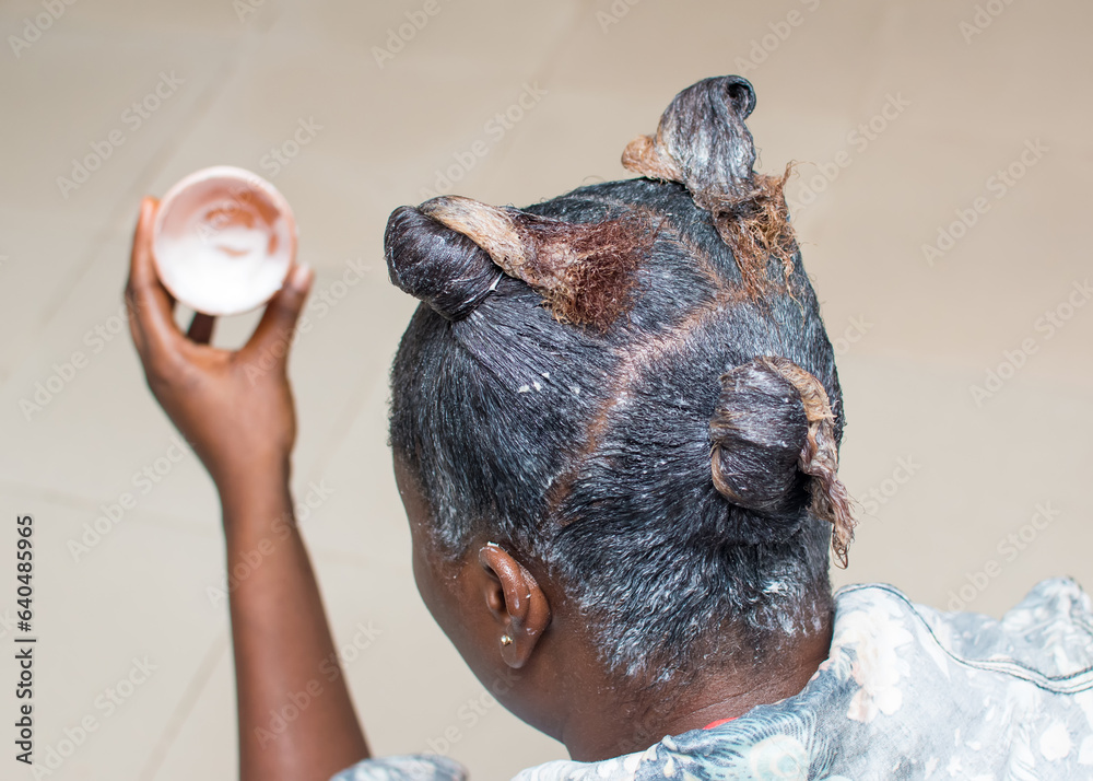 Head of an African Nigerian female woman whose hair is undergoing a ...