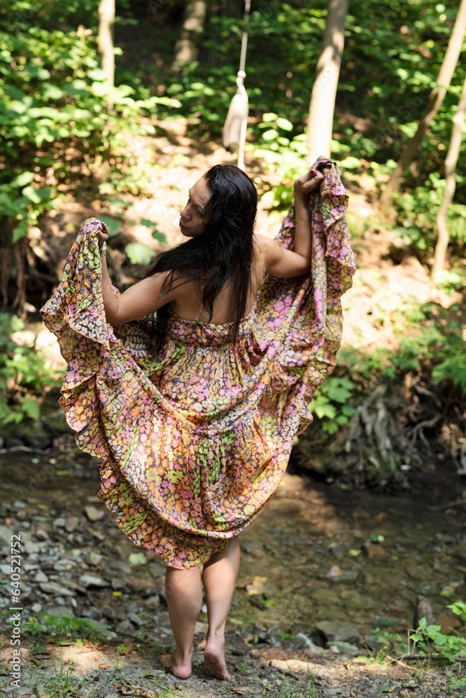 Natural fashion and stylish dress posing by woman in a forest among ...