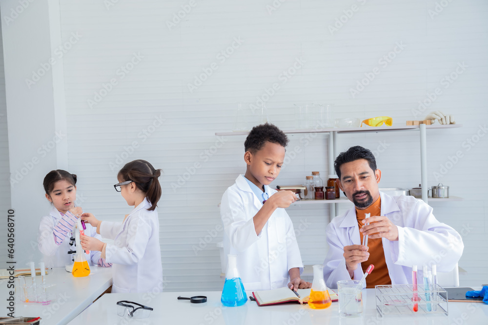 Cheerful group of Multicultural primary school students wearing lab ...