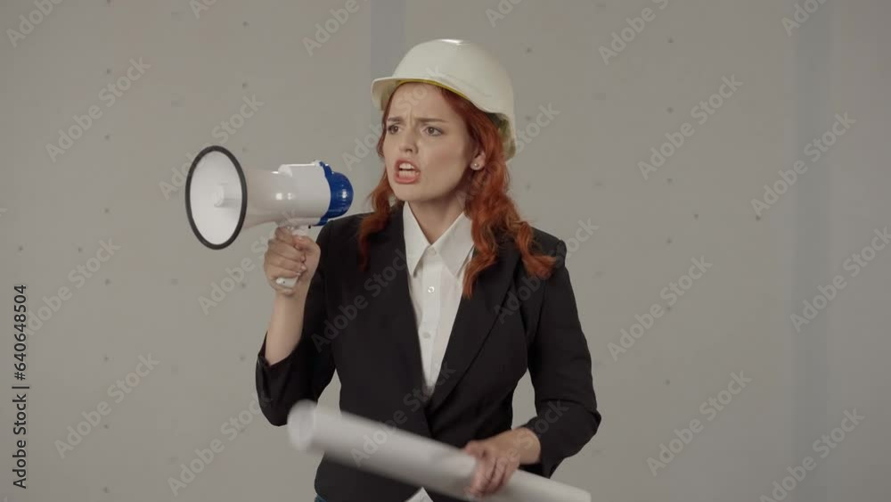 A woman in a protective helmet and drawings in her hand, screams, swears into a bullhorn. A ...