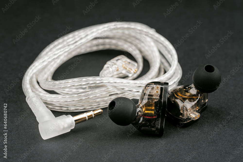 In ear monitor on a tablature background. Custom in-ear monitors with ...
