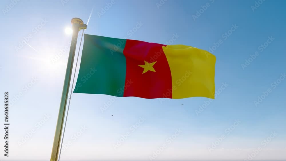 Flag of Cameroon waving in the wind, sky and sun background. Cameroon ...