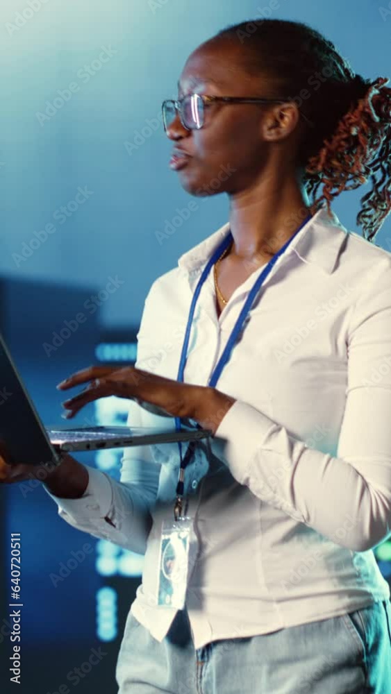 Vertical video Computer scientist programming in server farm housing ...