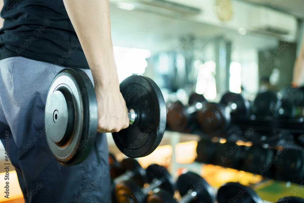 Active Asian sportsman doing a weight exercise in a gym - fitness by ...