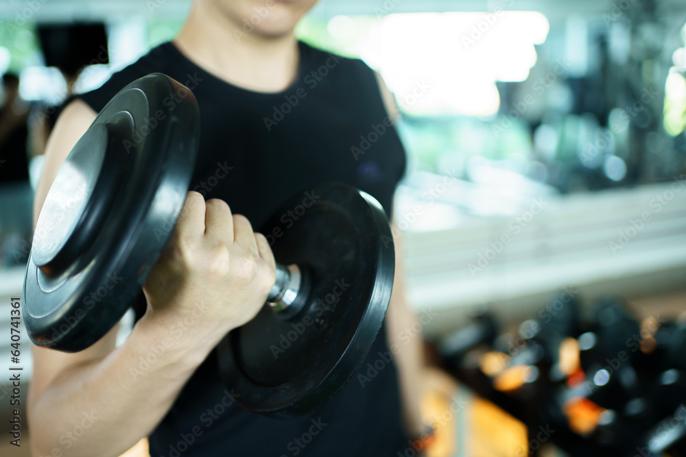 Active Asian sportsman doing a weight training exercise by lifting up a ...
