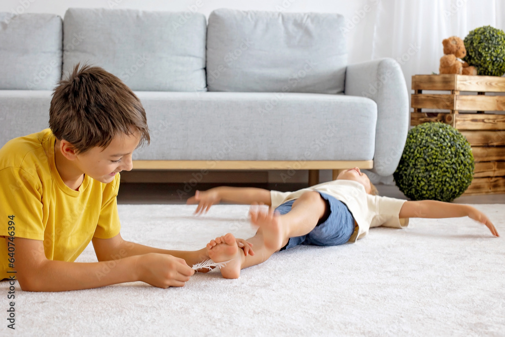 Happy positive children, tickling on the feet, having fun together, boy ...