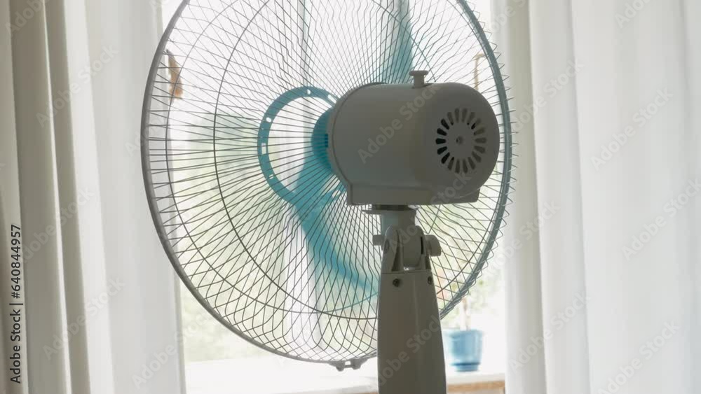 An artificial cooler in the apartment, an electric fan cools the air of ...