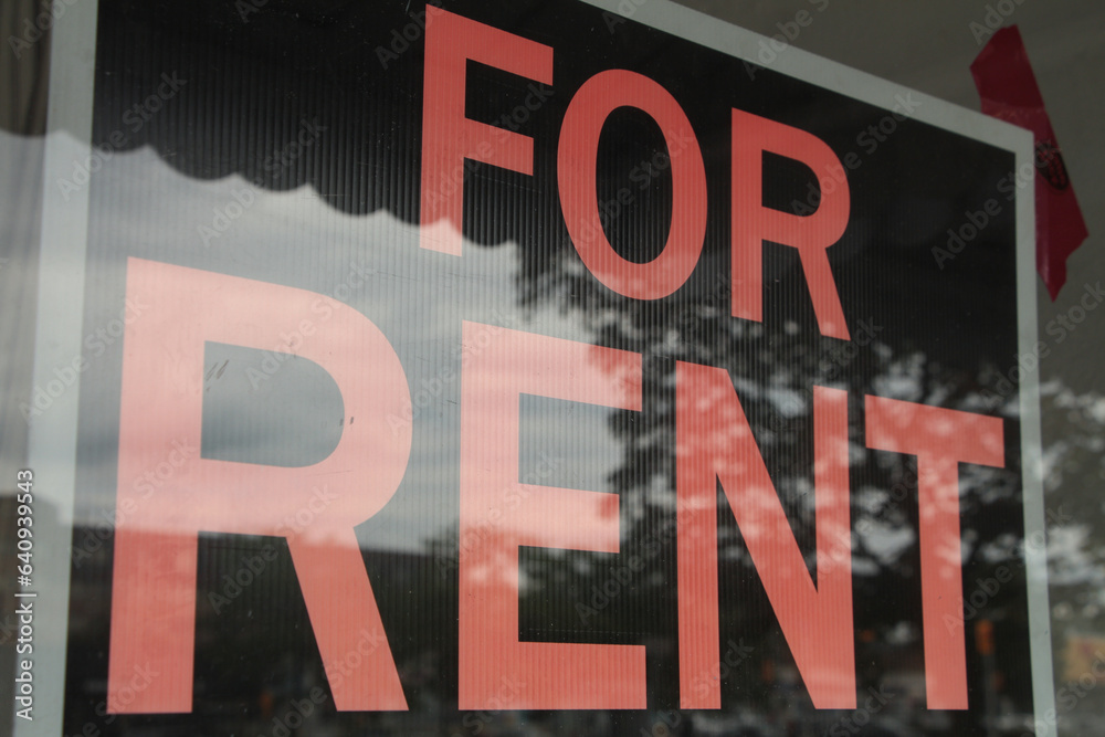 for rent sign inside window, red capital letters with black background ...