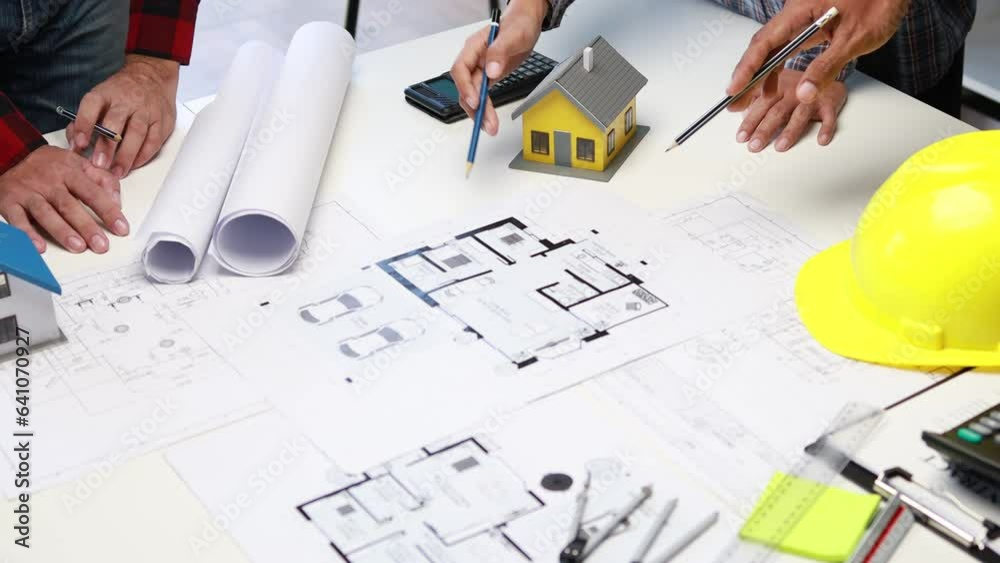 The home design architects are reviewing the house plan draft, the ...