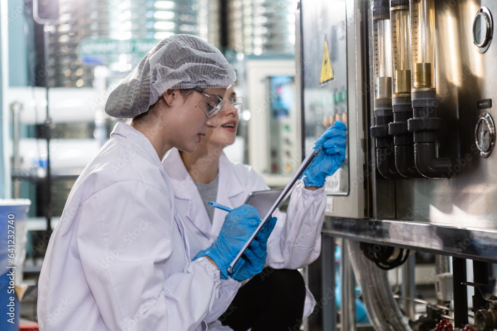 Female worker checking quality process of filtering cleanliness ...