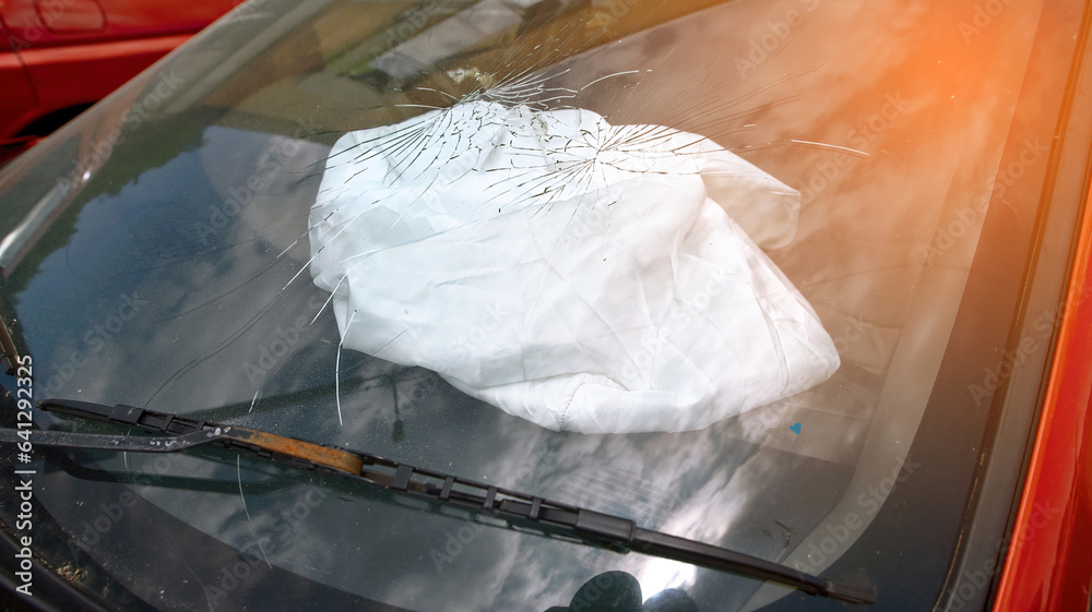 Cracked, damaged windshield and blown airbag after head on collision ...