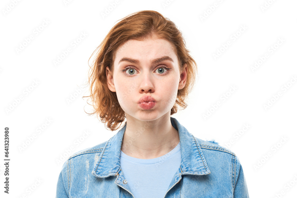 Portrait of young redhead woman puffing cheeks with funny face isolated ...