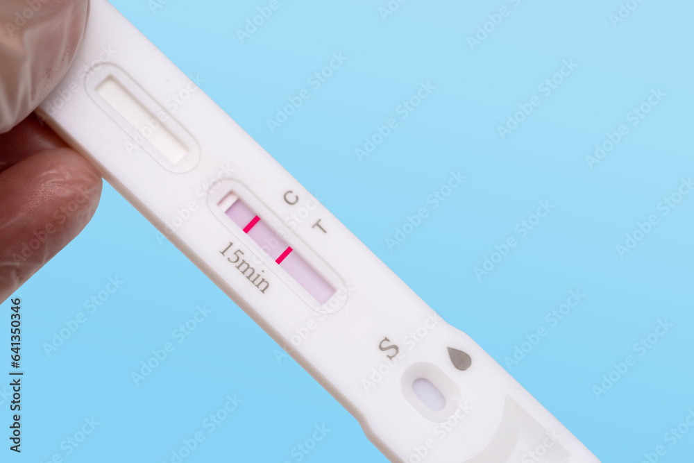 positive test for covid, antigenic test cassette, conducting rapid test ...