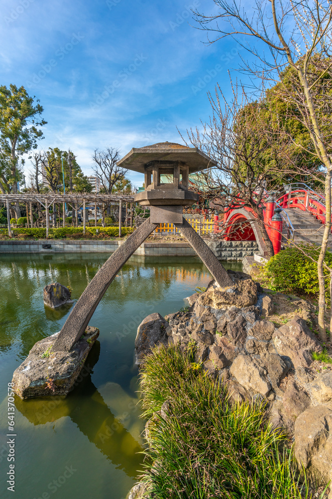 Tokyo, Japan - March 18, 2019 : Stone Lantern and pond of Kameido ...