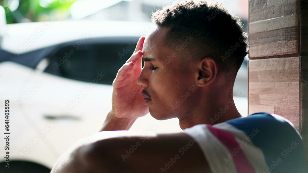 One preoccupied young black Brazilian man struggling with regret and ...