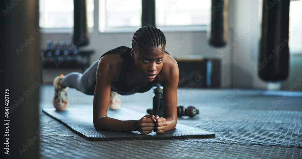 Serious, plank and a black woman at the gym for fitness, strong and ...