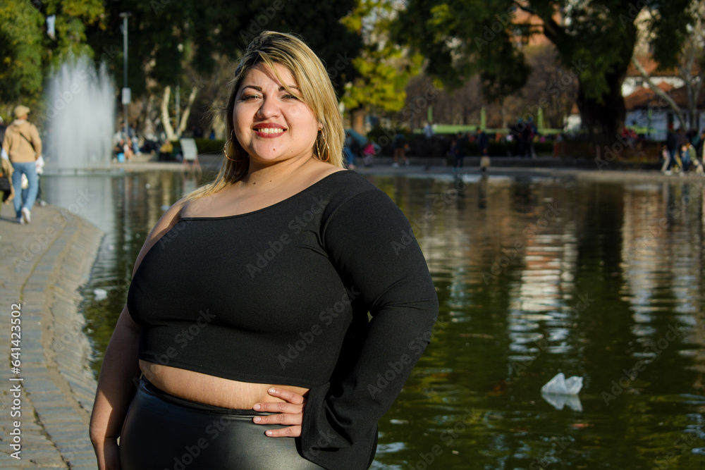 young plus size latina woman standing posing with her hands on her ...