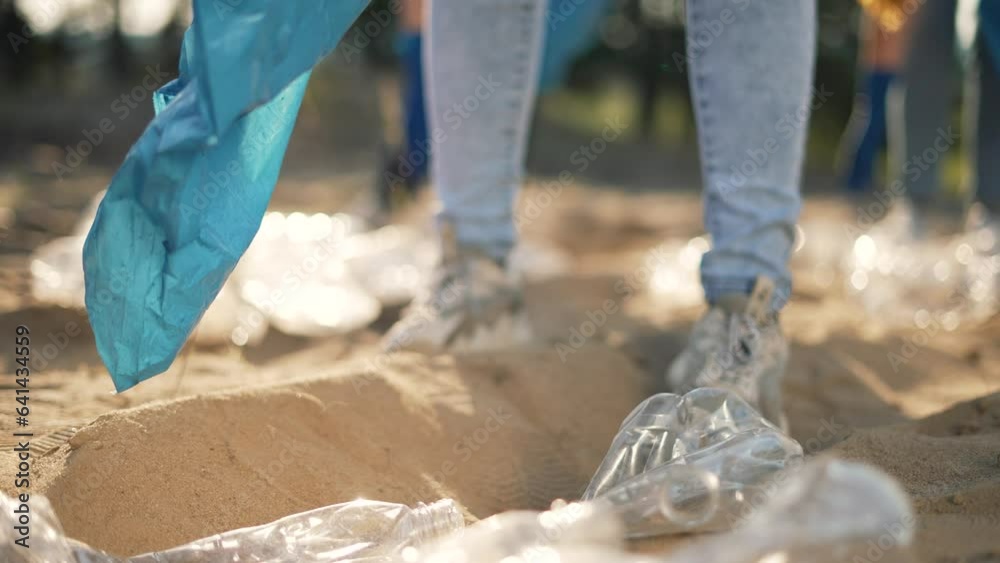 Teamwork.Cleaning plastic garbage in bag on beach in summer ...