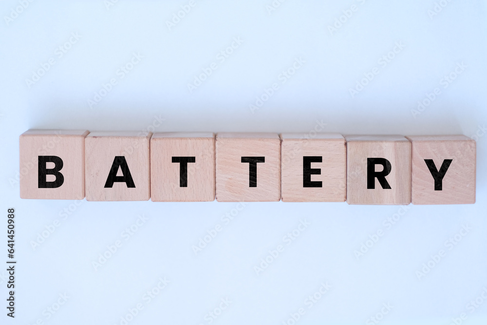 Battery text on ordered block cubes, power or electrical idea, wooden ...
