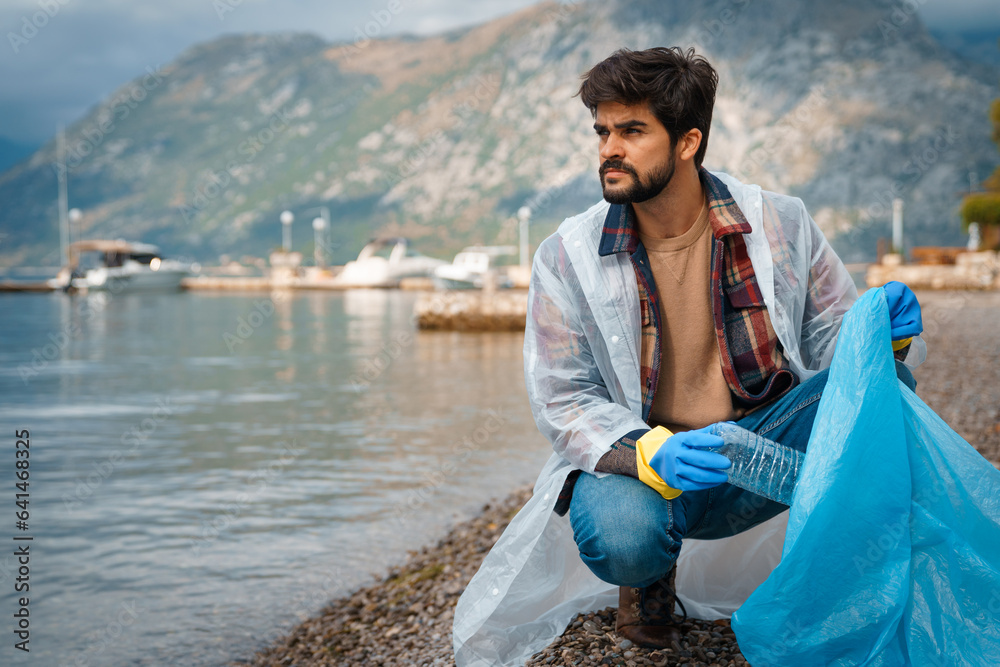 Handsome serious millennial man looking into the distance while ...