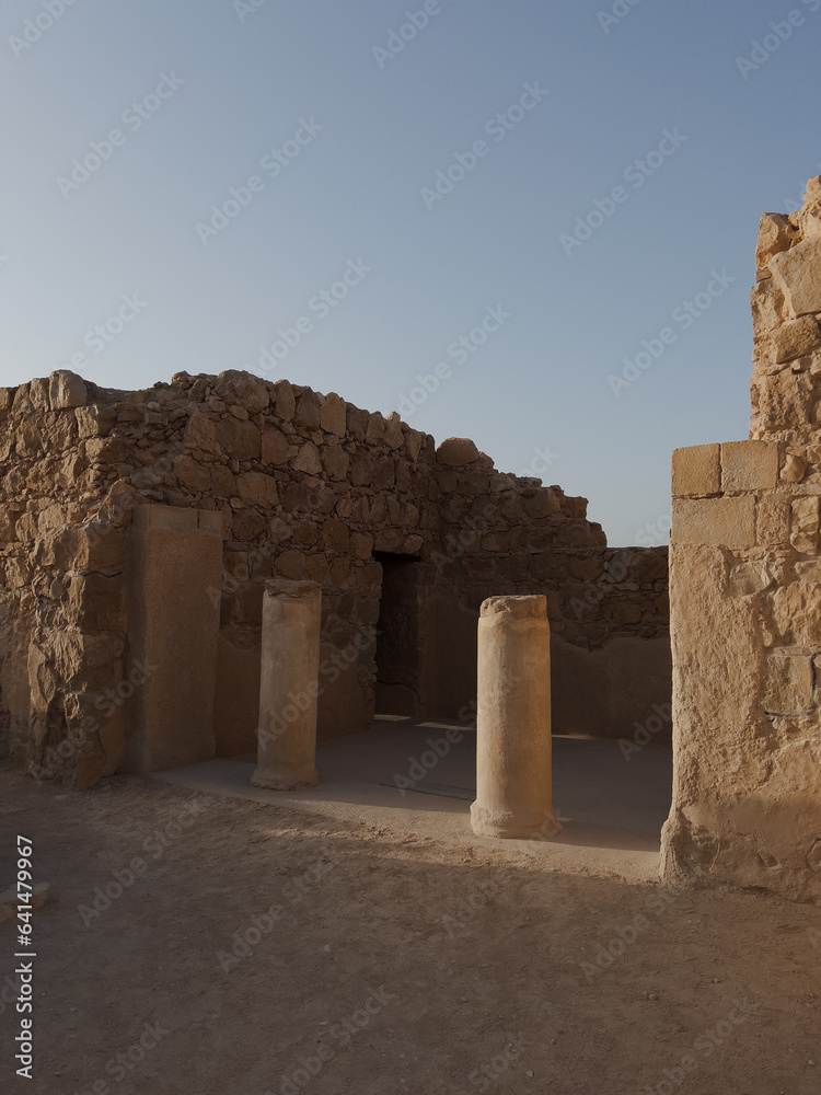 At the ancient archaeological site of Masada, stone columns line a ...