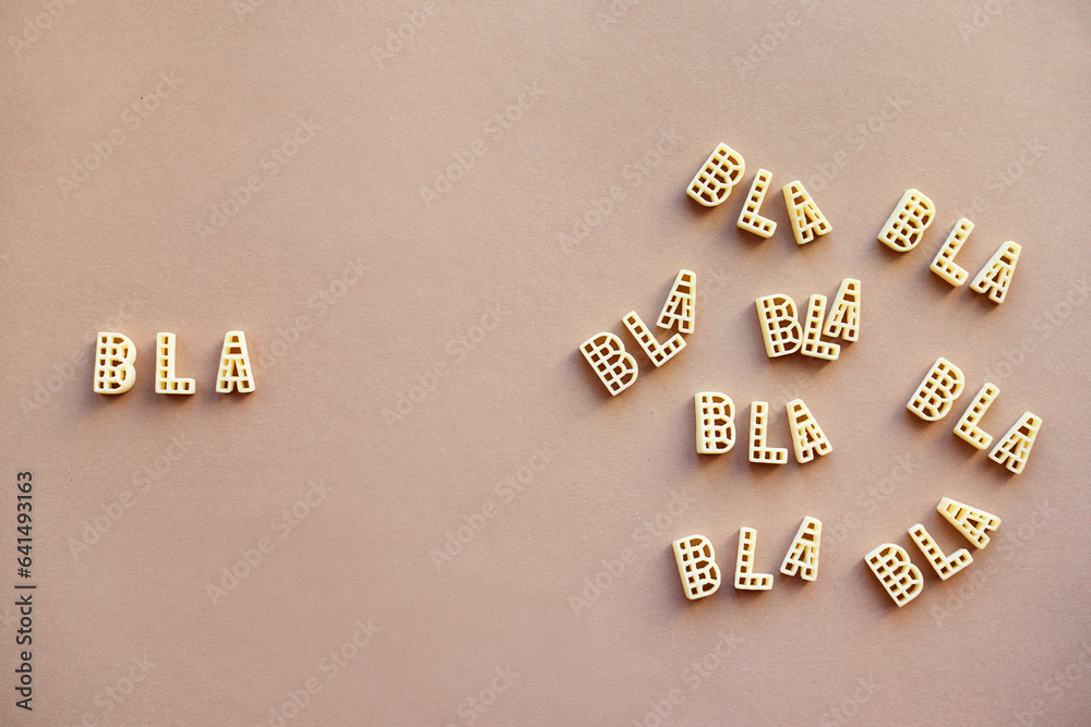 Conceptual photo of multiple words ‘bla’ made up of alphabet pasta ...