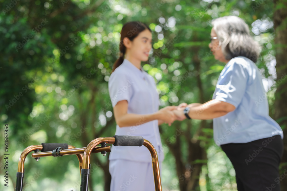 Elderly women using walking aids for exercises to improve muscle ...